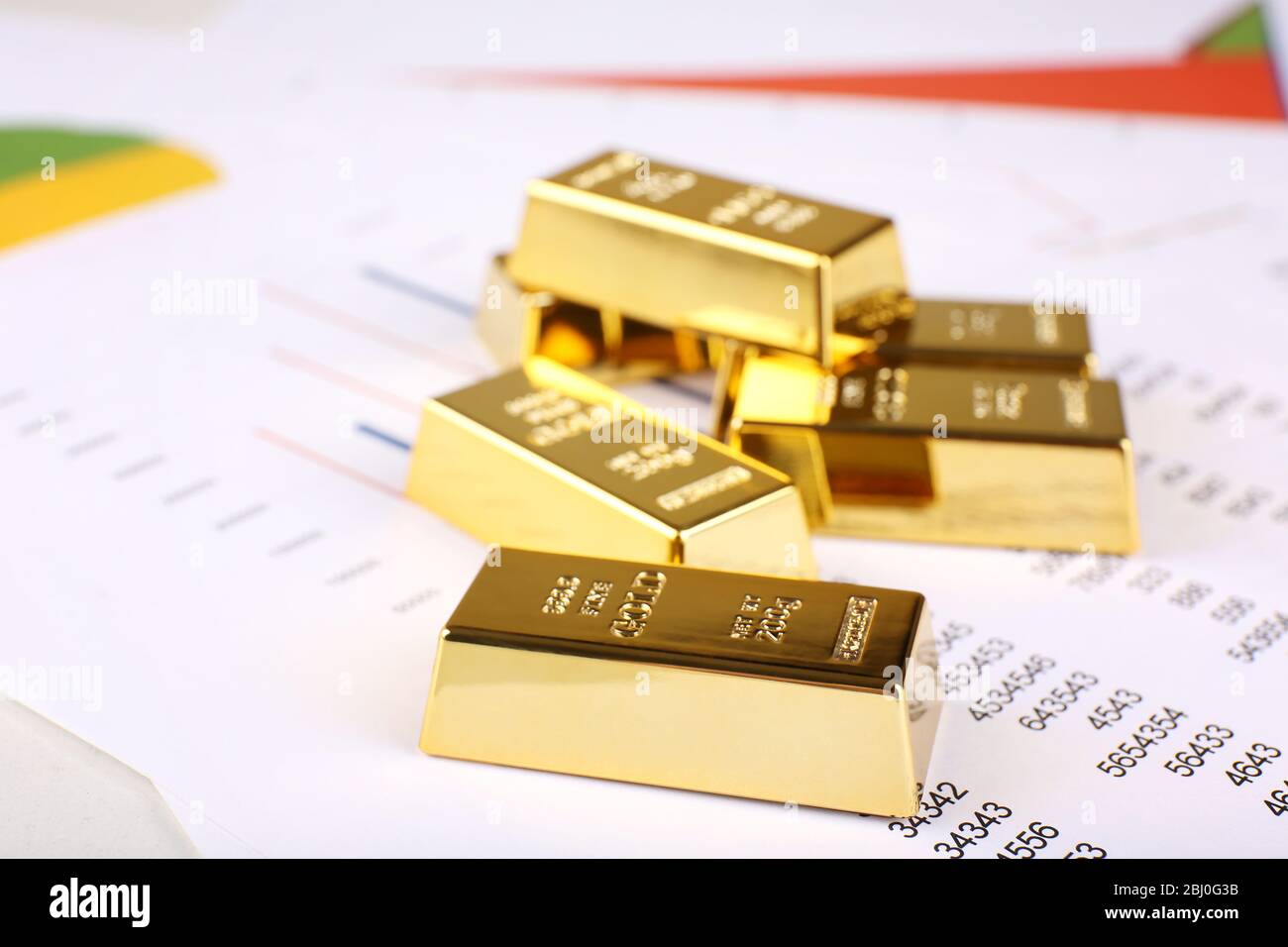 Gold bullion on documents background Stock Photo - Alamy