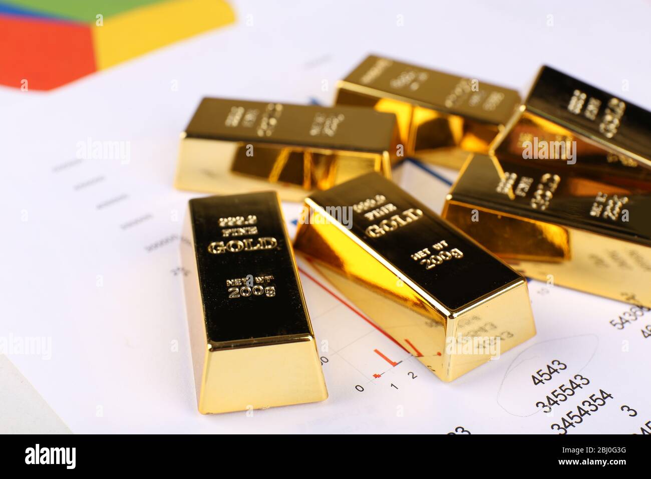 Gold bullion on documents background Stock Photo - Alamy