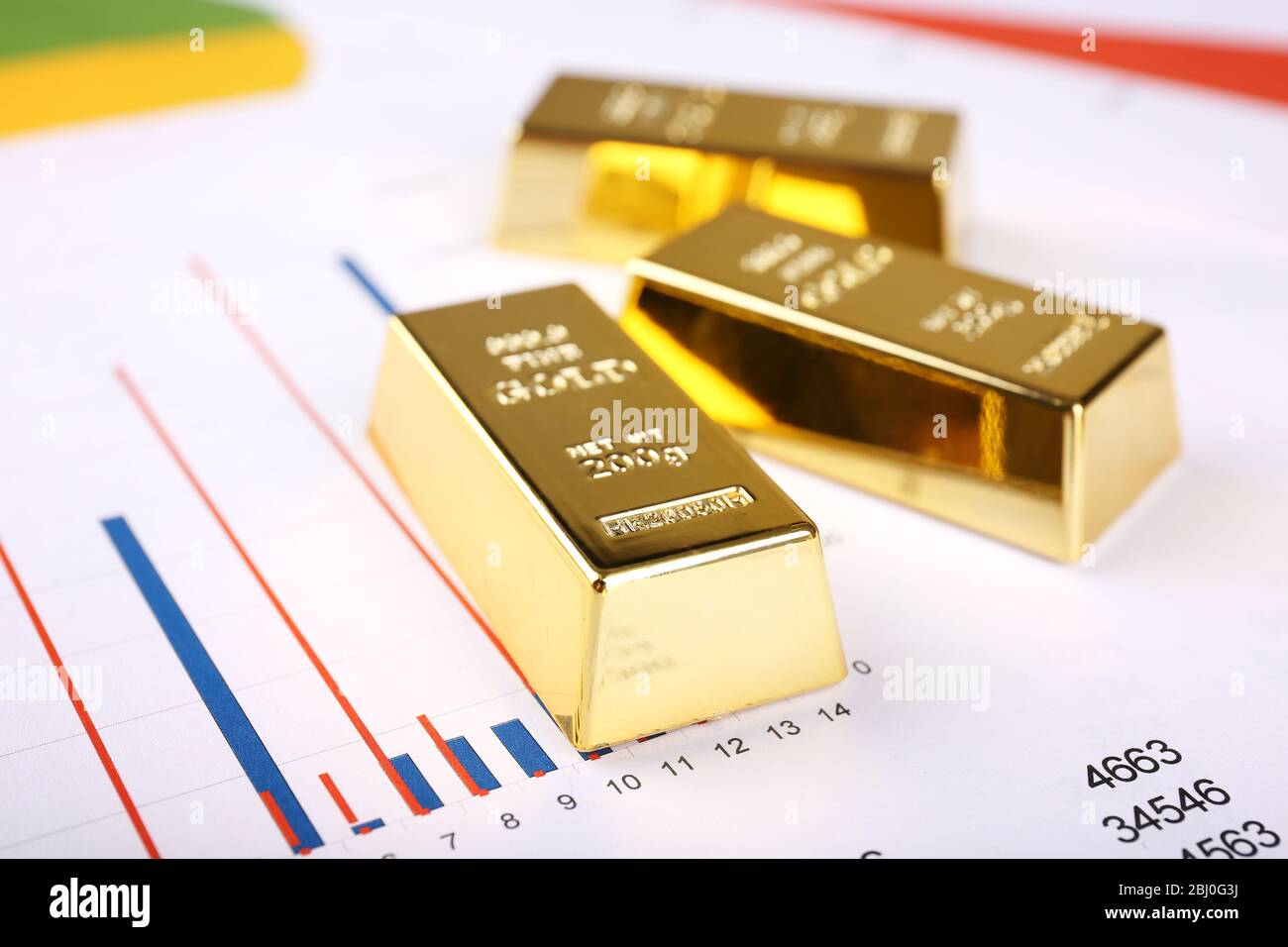 Gold bullion on documents background Stock Photo - Alamy