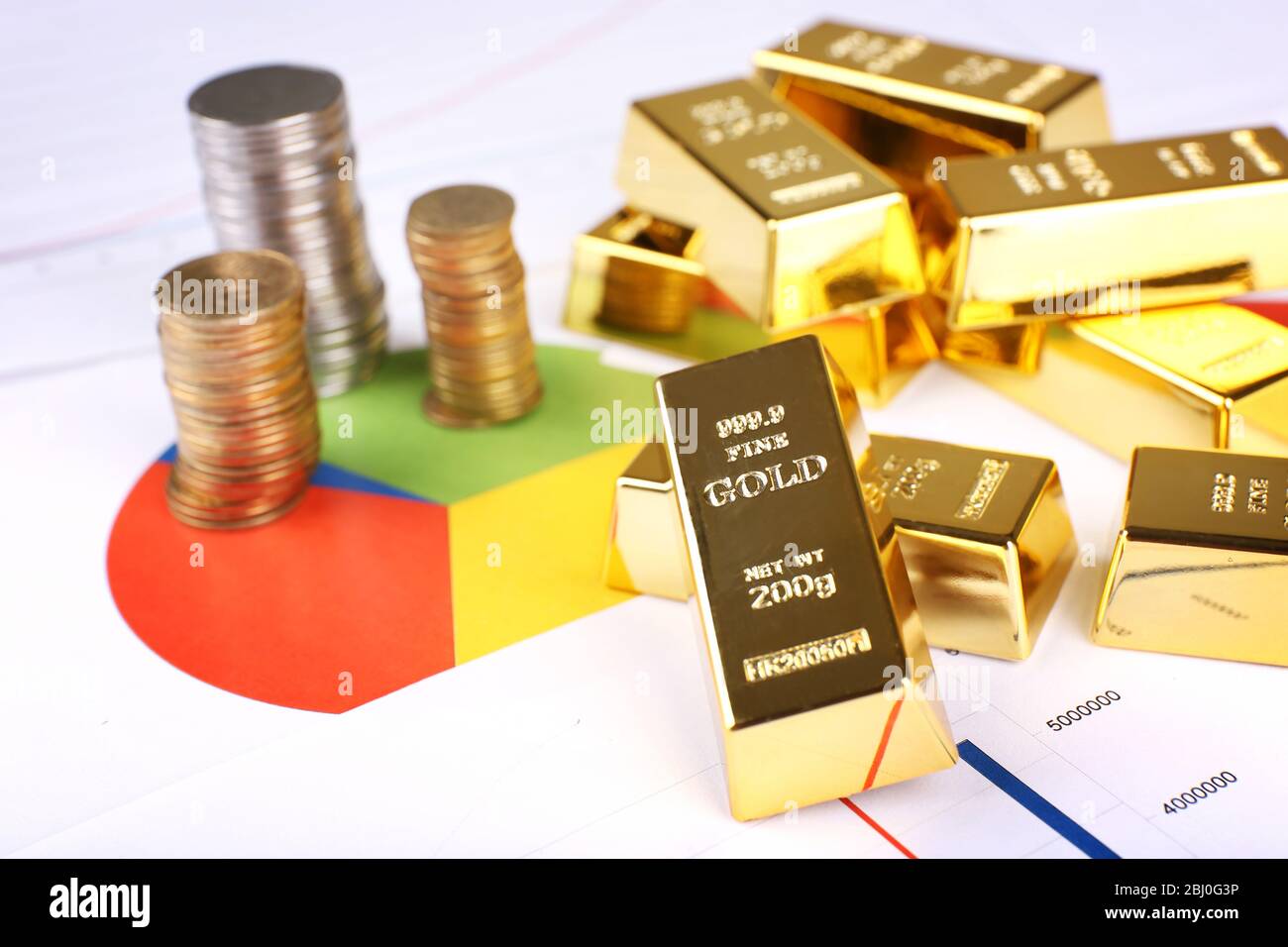 Gold bullion with coins on documents background Stock Photo - Alamy