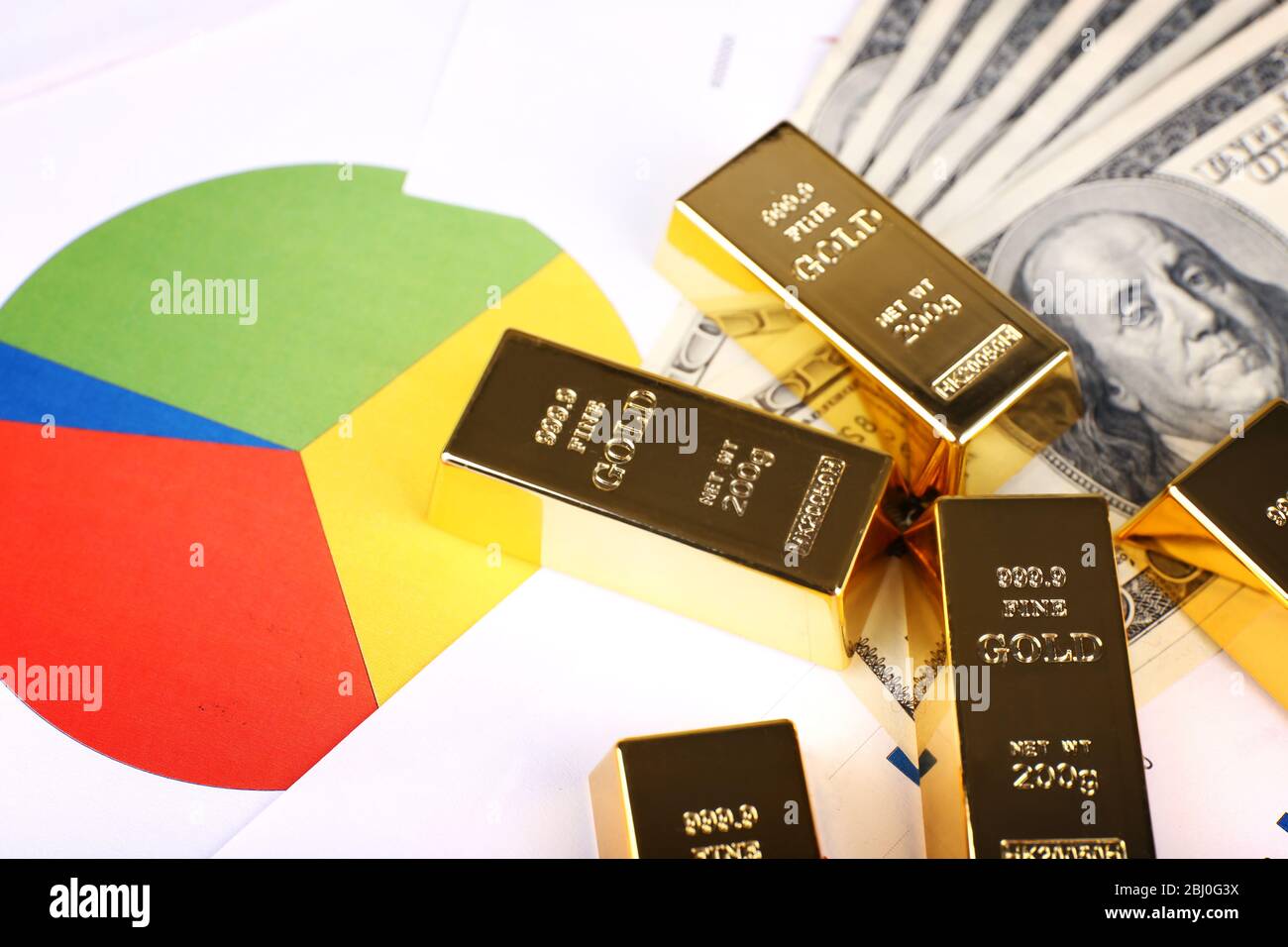 Gold bullion with money on table close up Stock Photo - Alamy