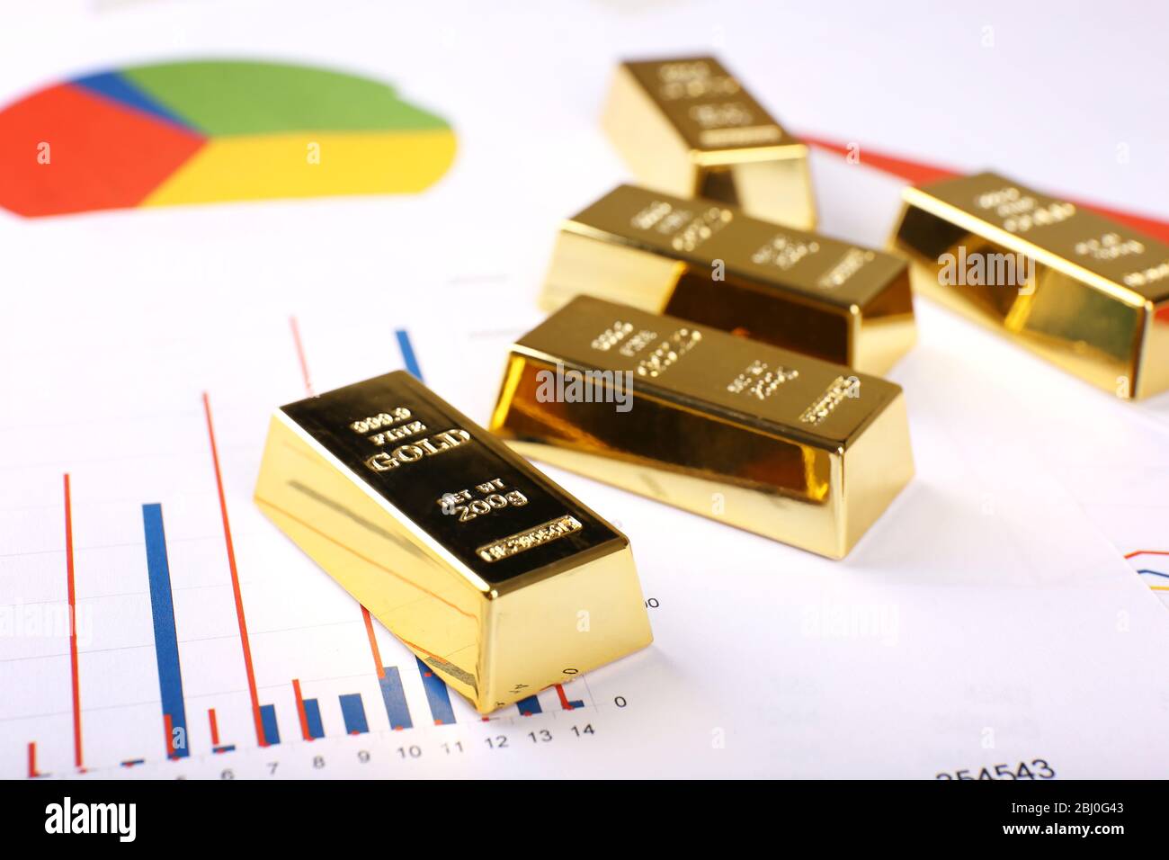 Gold bullion on documents background Stock Photo - Alamy