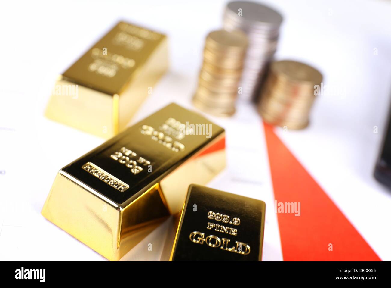 Gold bullion with coins on documents background Stock Photo - Alamy