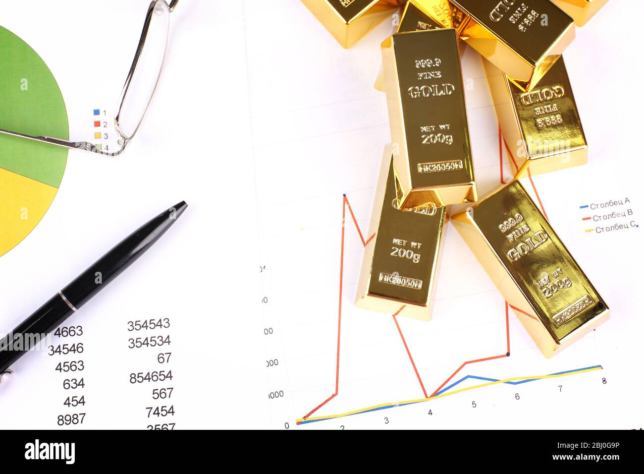 Gold bullion on documents background Stock Photo - Alamy