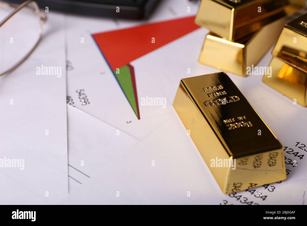 Gold bullion on documents background Stock Photo - Alamy