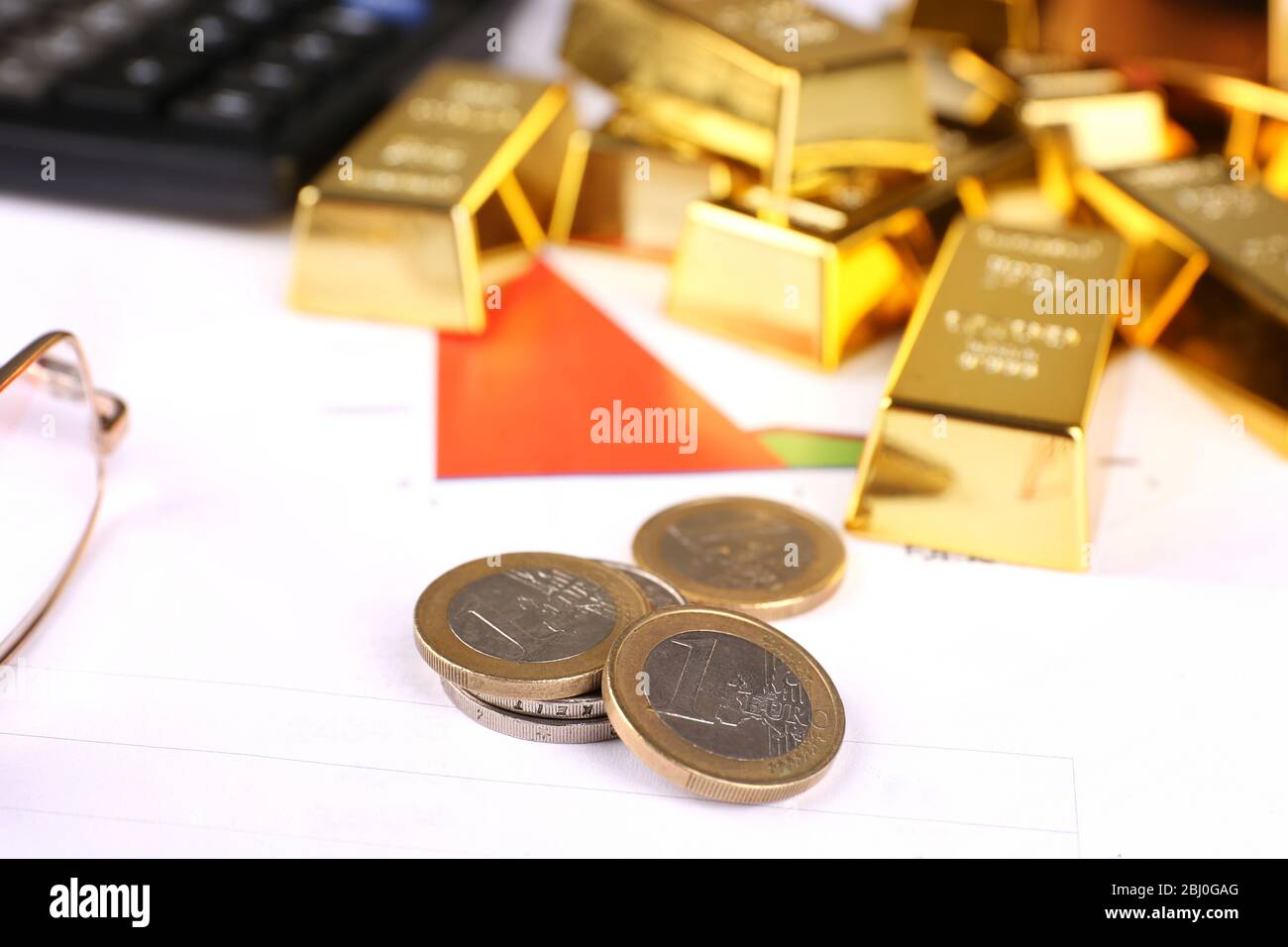 Gold bullion with coins on documents background Stock Photo - Alamy