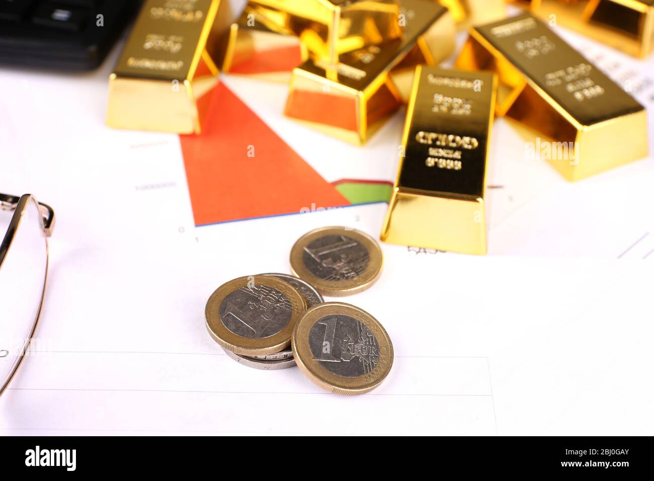 Gold bullion with coins on documents background Stock Photo - Alamy