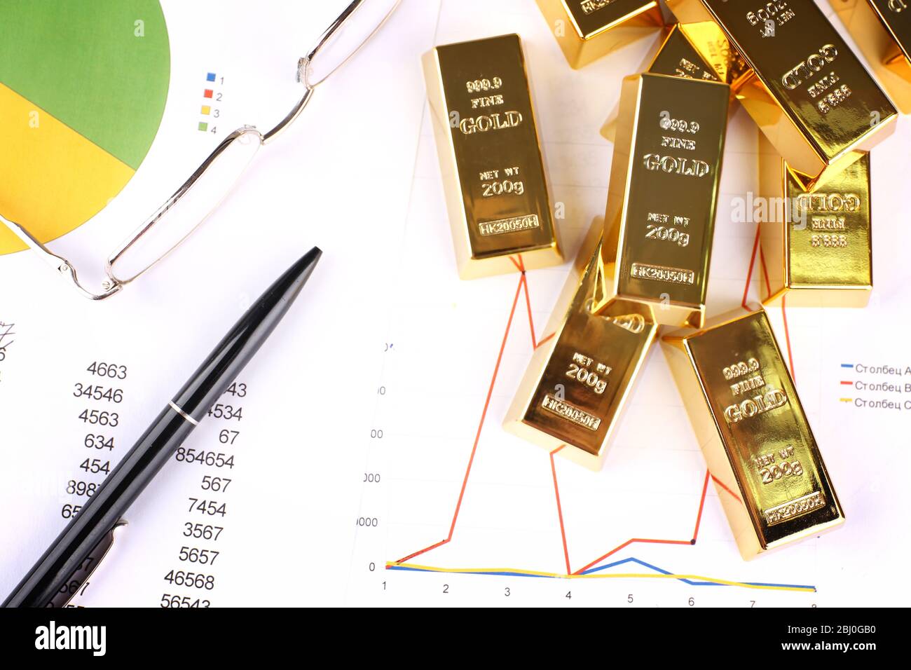 Gold bullion on documents background Stock Photo - Alamy
