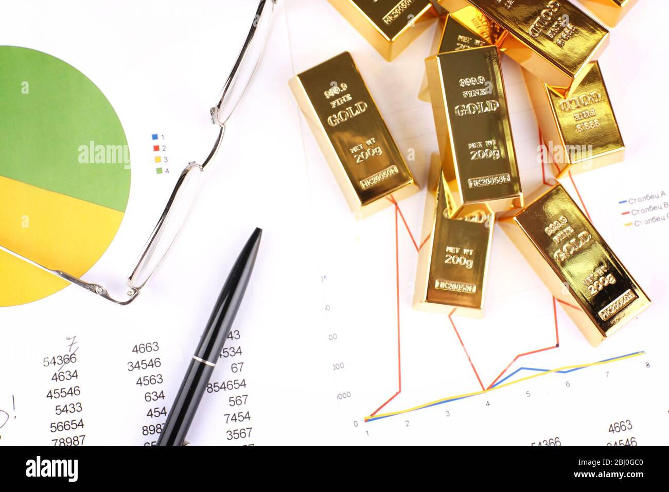 Gold bullion on documents background Stock Photo - Alamy