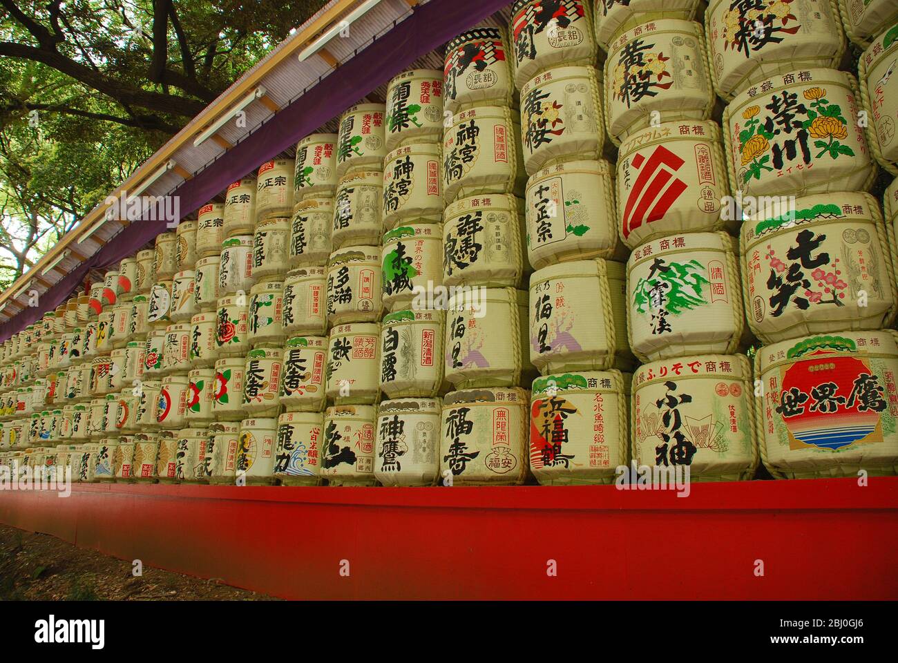 A display of sake barrels in the gardens of Meiji Jingu Temple in Tokyo ...
