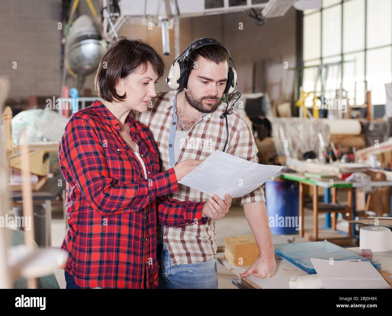 Team of aircraft enthusiasts working in workshop on creating of ...
