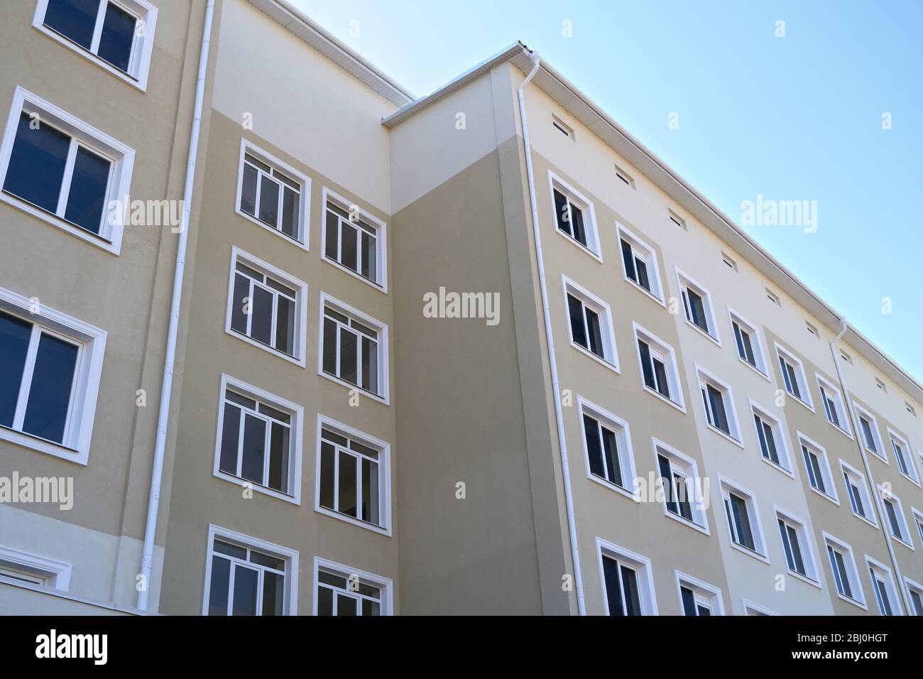 facade of a new multi-storey building with many windows Stock Photo - Alamy