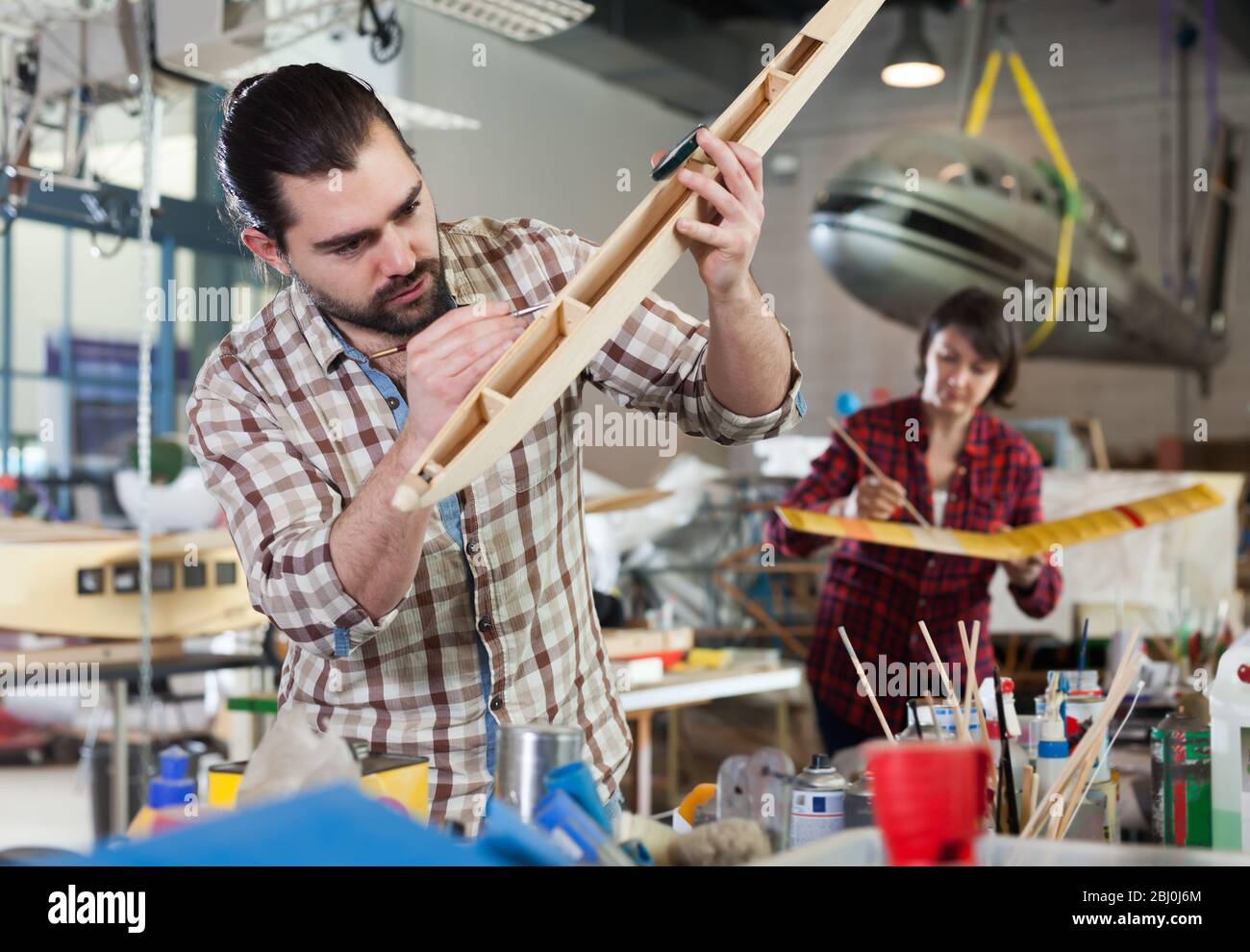 Lucky male aircraft enthusiast working in workshop on creating of ...