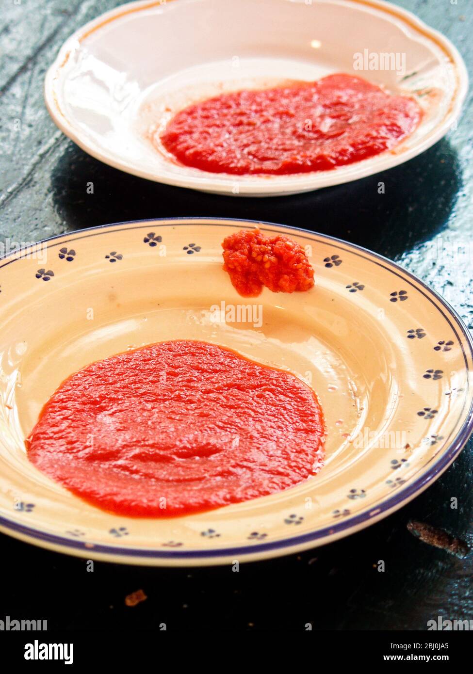 Two sorts of tomato puree - passata and passata rustico on italian ...