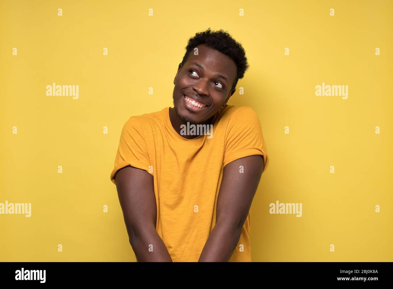 african american man in yellow clothes, smiling broadly Stock Photo - Alamy
