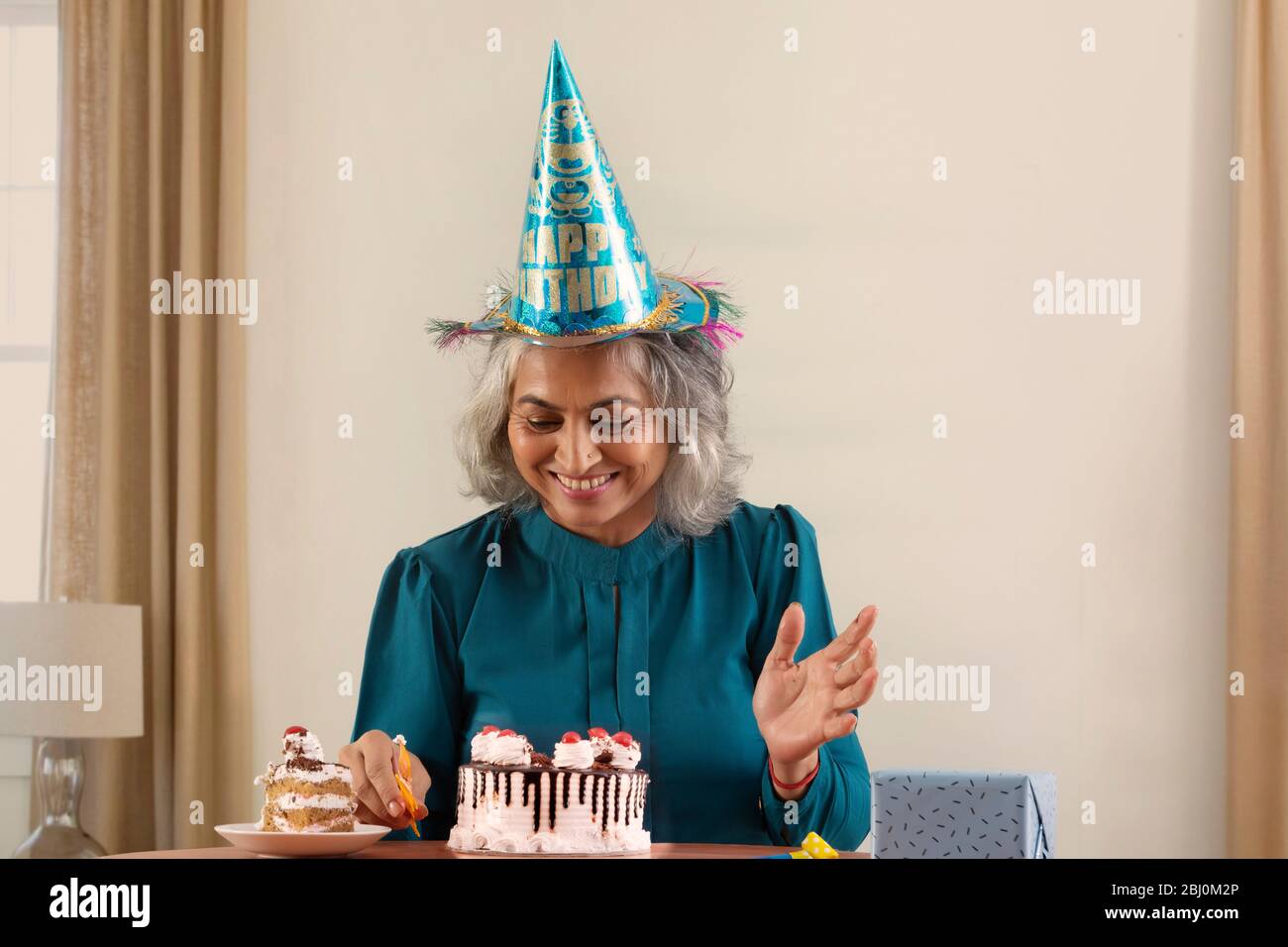 Portrait of a grandmother celebrating her birthday. (Senior Stock Photo ...