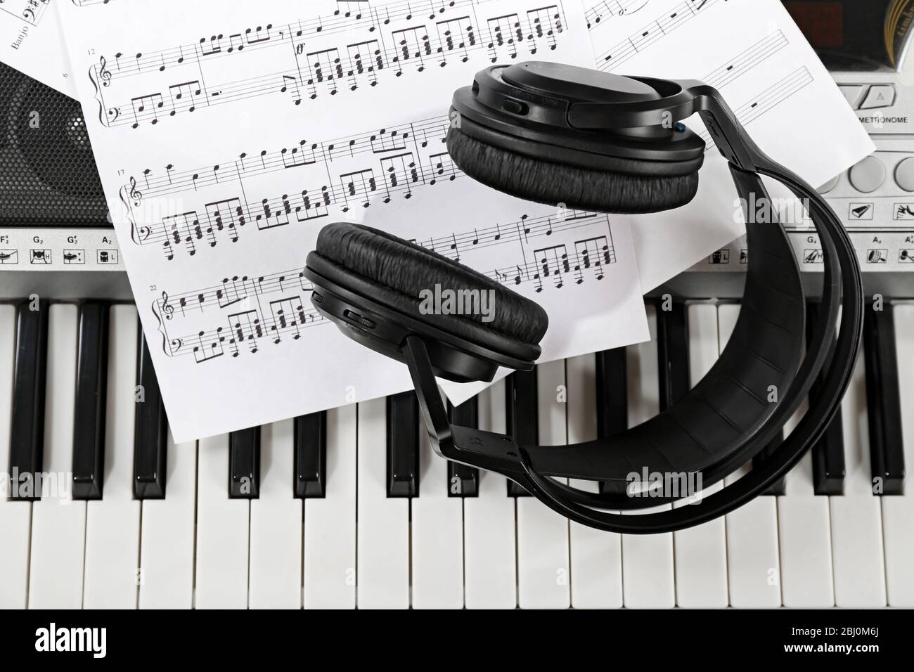 Headphones with music notes on synthesizer close up Stock Photo - Alamy