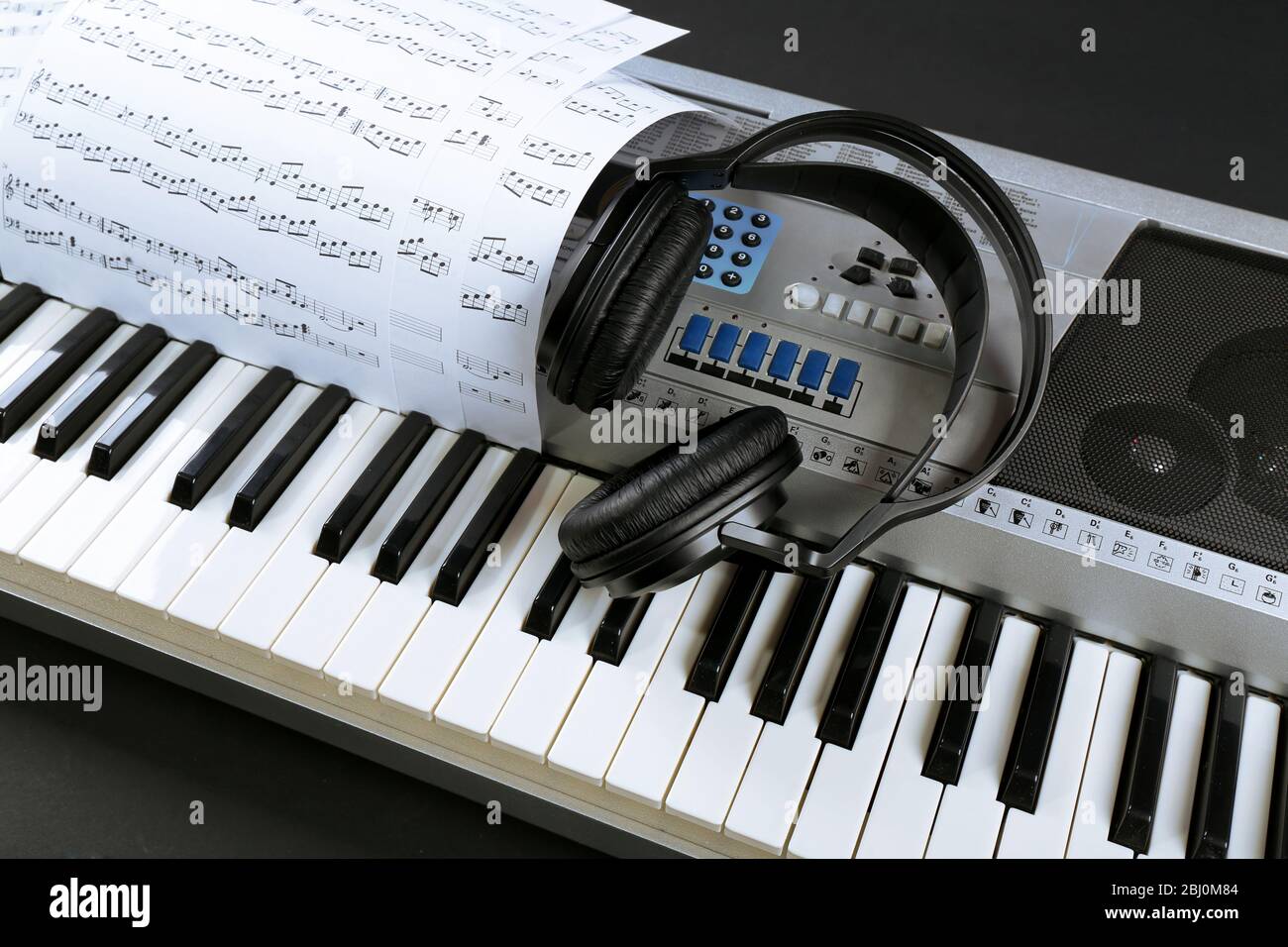 Headphones with music notes on synthesizer close up Stock Photo - Alamy