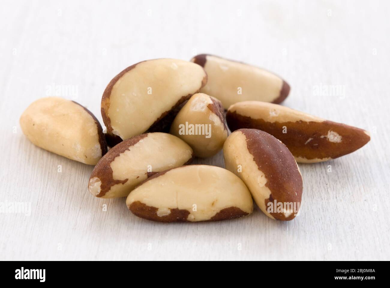 Shelled brazil nuts on white surface Stock Photo - Alamy