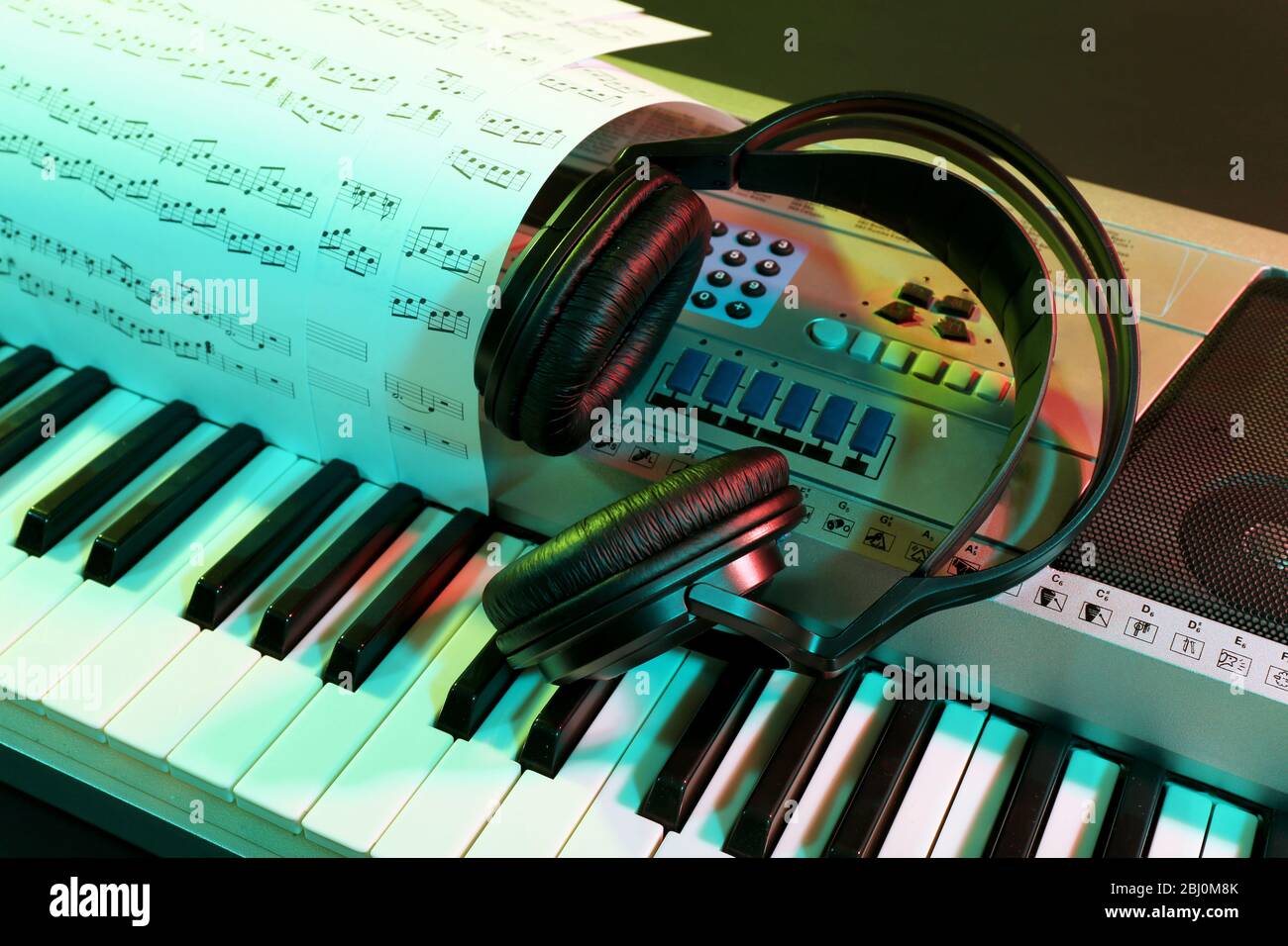 Headphones with music notes on synthesizer close up Stock Photo - Alamy