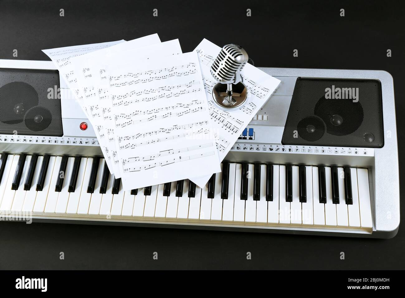 Music notes with microphone on synthesizer on gray background Stock ...
