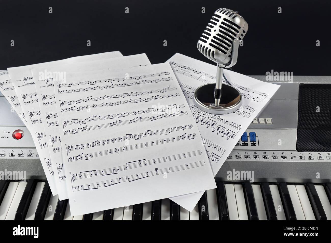 Music notes with microphone on synthesizer on gray background Stock ...