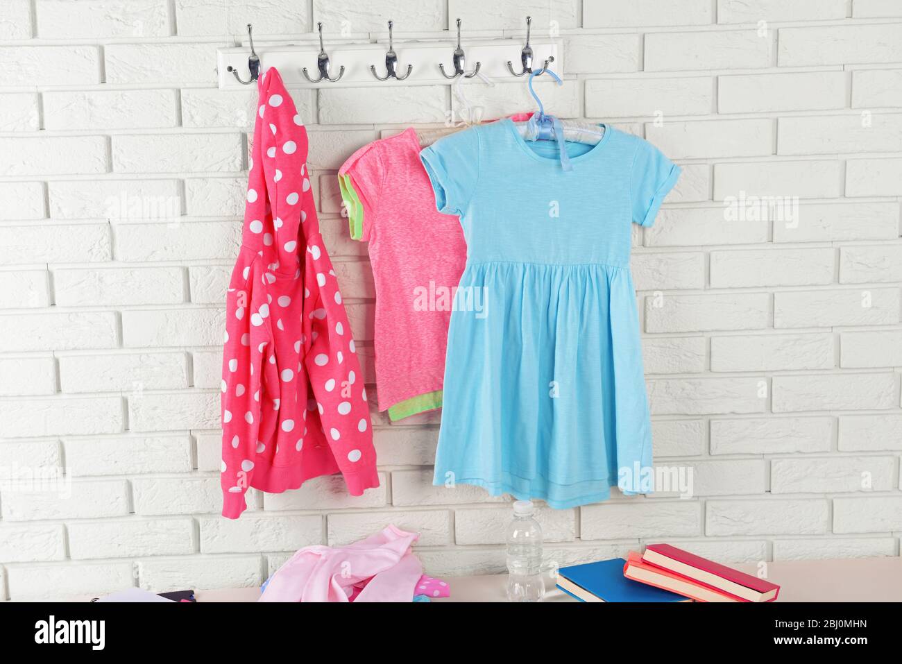 Children things hanging on wall and stacked in room Stock Photo - Alamy