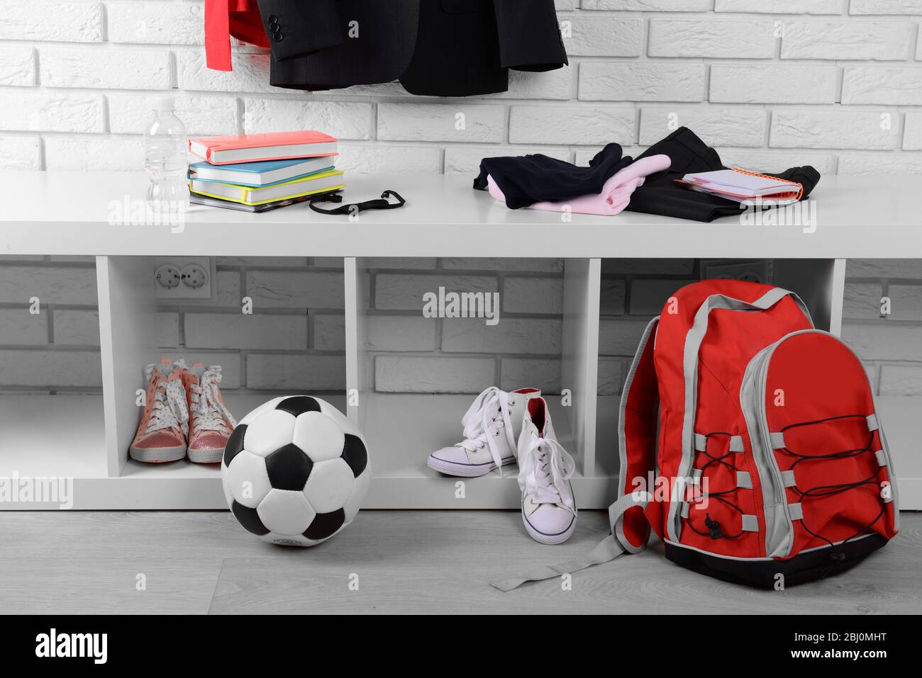 Children things hanging on wall and stacked in room Stock Photo - Alamy