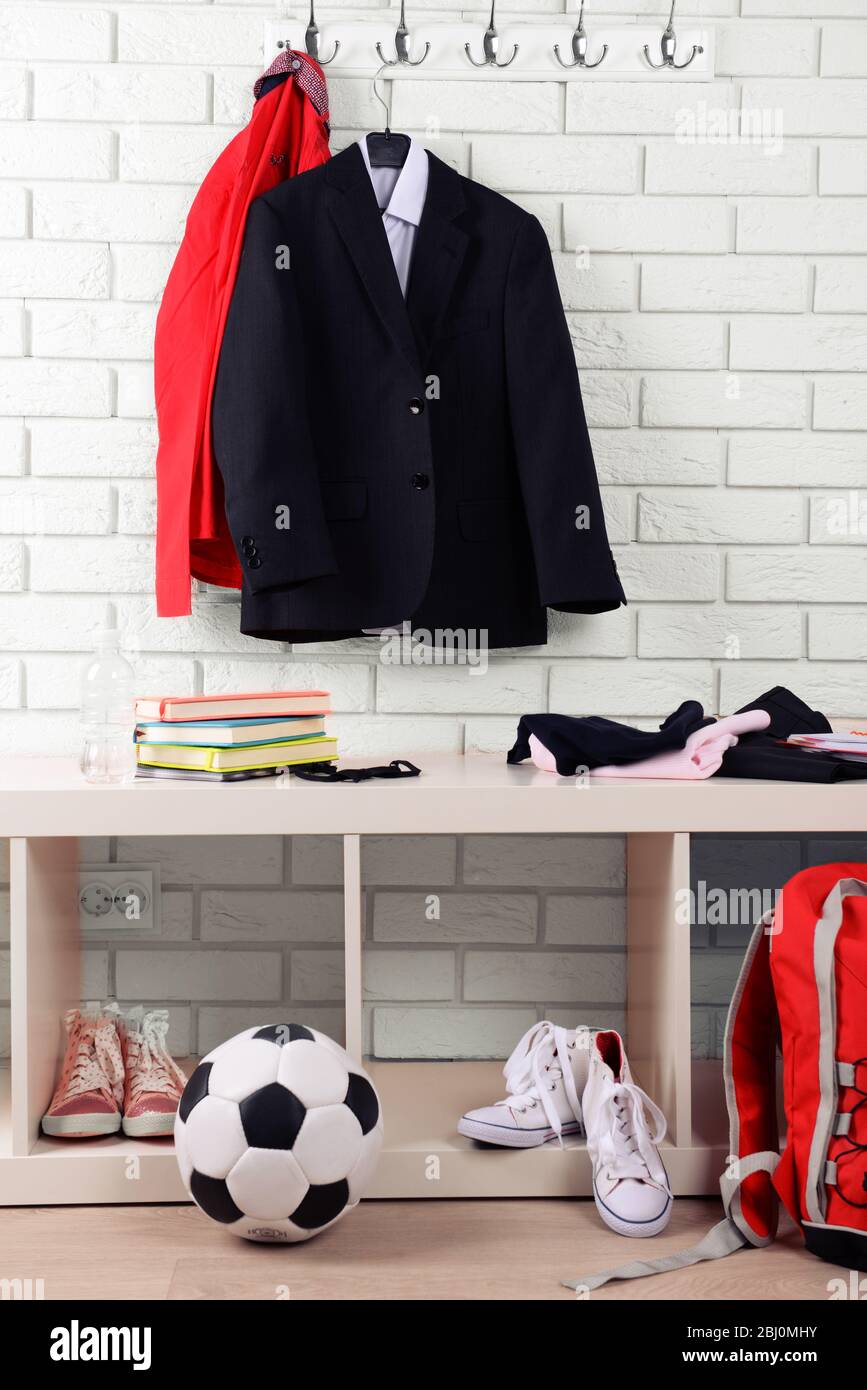 Children things hanging on wall and stacked in room Stock Photo - Alamy