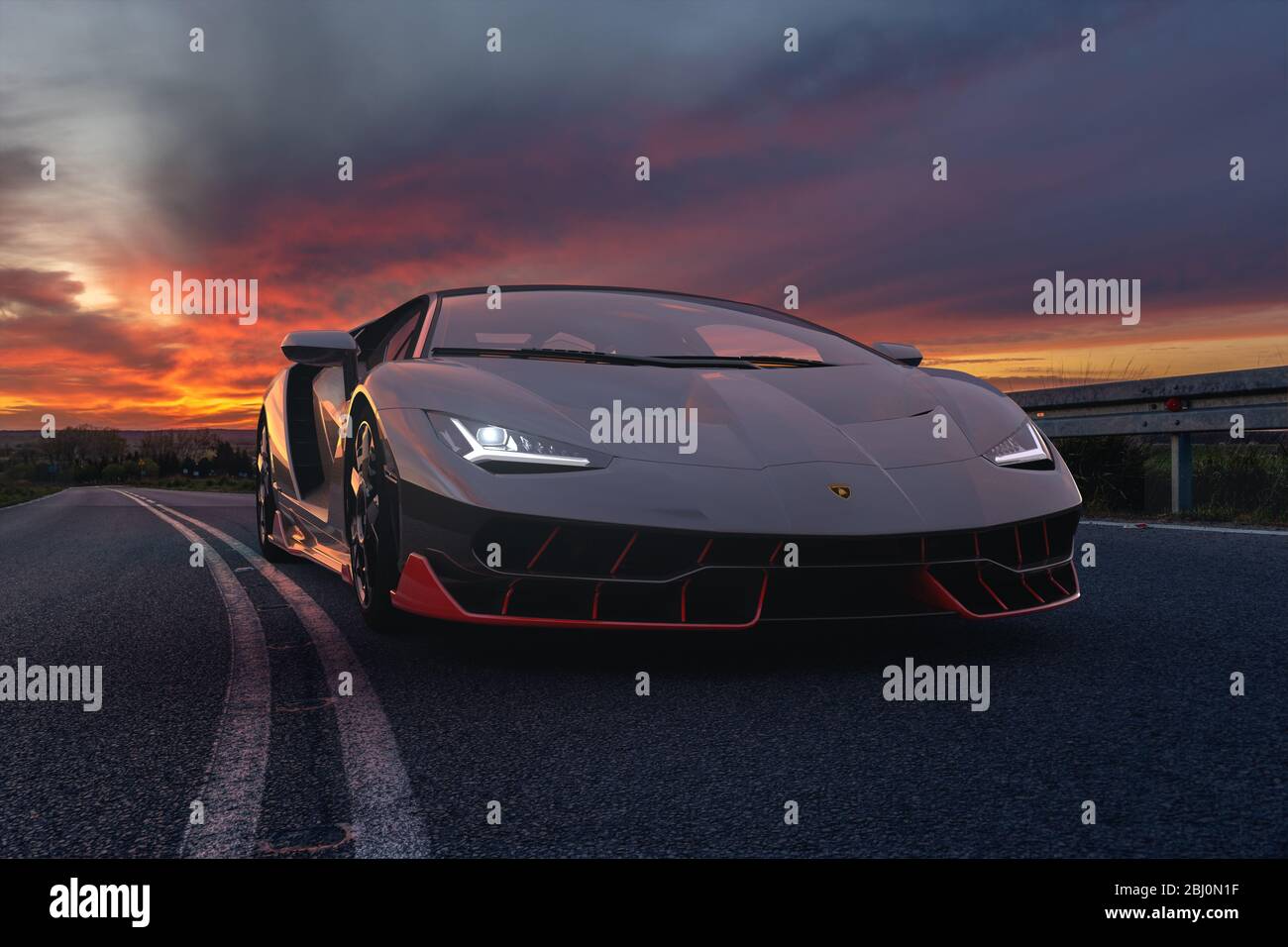 Lamborghini supercar driving down the road during a dramatic sunset ...