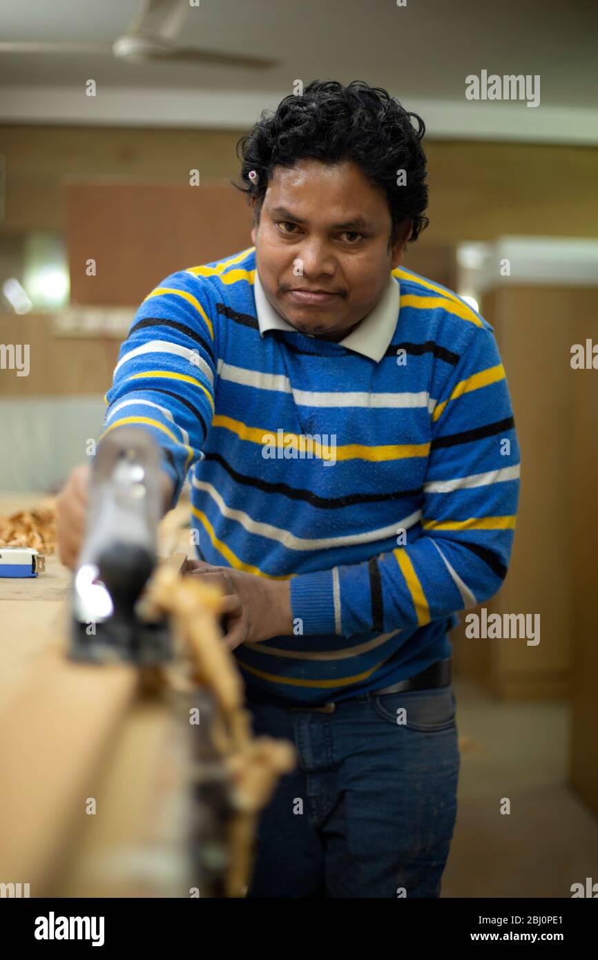 Carpenter shaping the edges of a wooden plank. (Common man Stock Photo ...