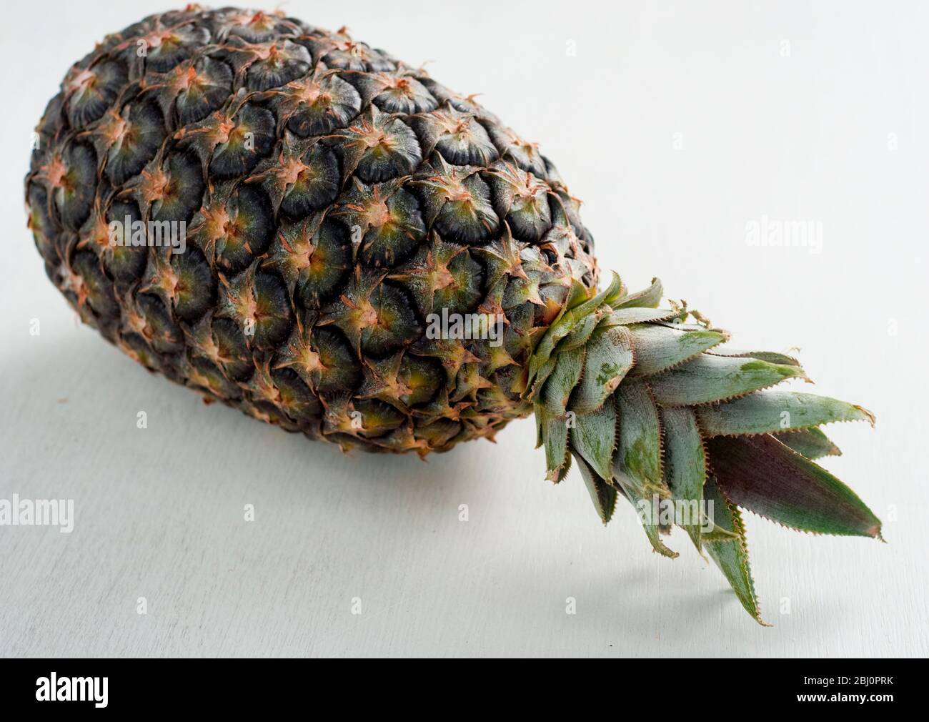 Fresh organic pineapple on white surface Stock Photo - Alamy
