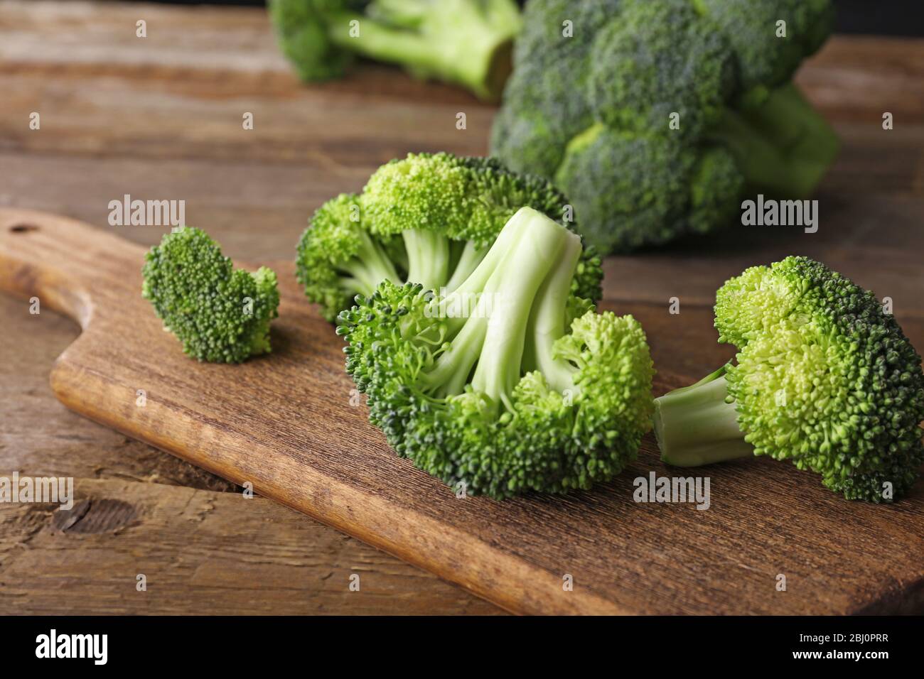 Fresh broccoli on wooden table close up Stock Photo - Alamy