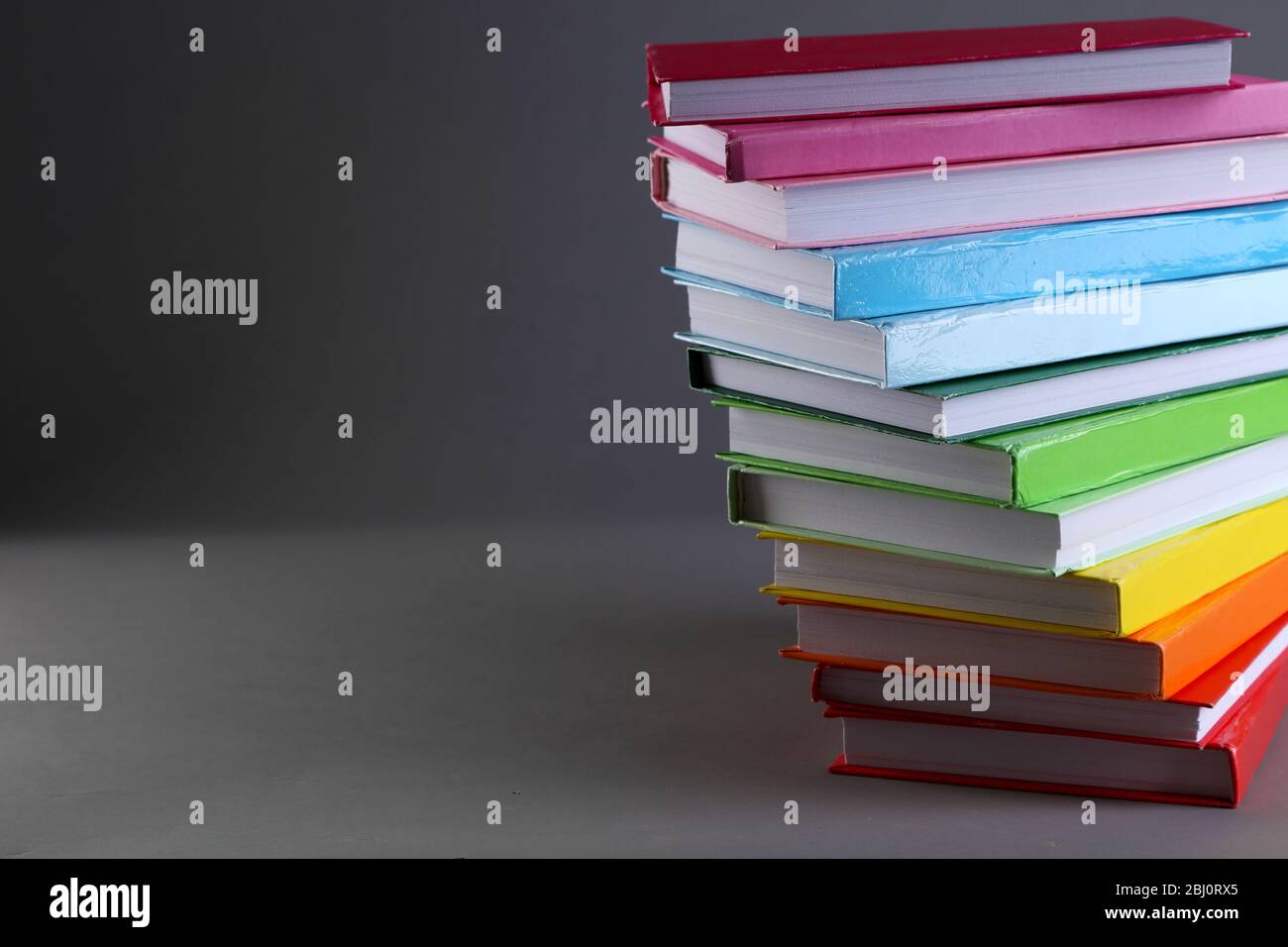 Colorful books on gray background Stock Photo - Alamy