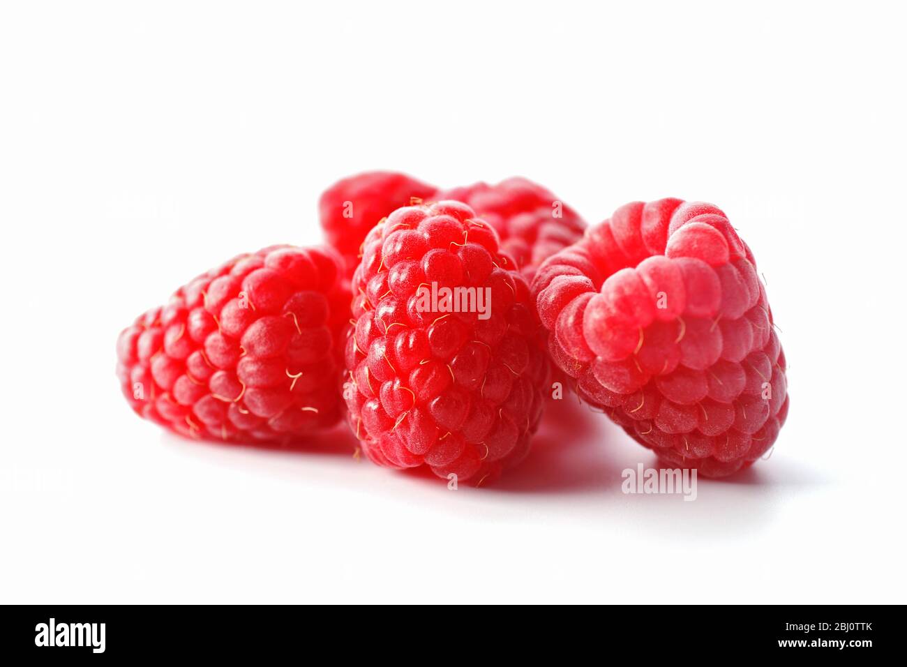 Red sweet raspberries isolated on white Stock Photo - Alamy