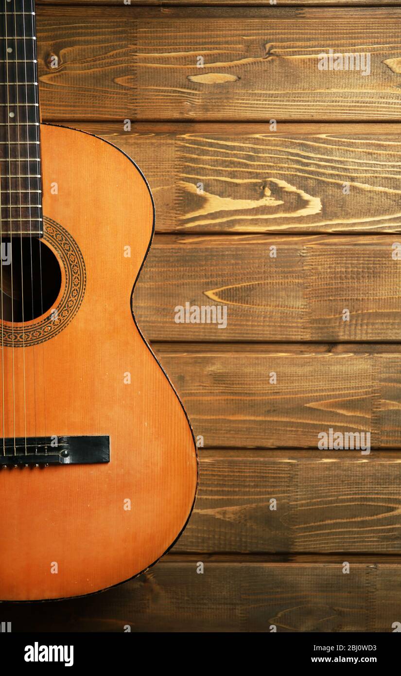 Classical guitar on wooden background Stock Photo - Alamy