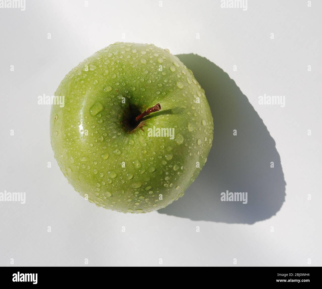 A green apple picked straight from the tree, washed and ready to eat ...