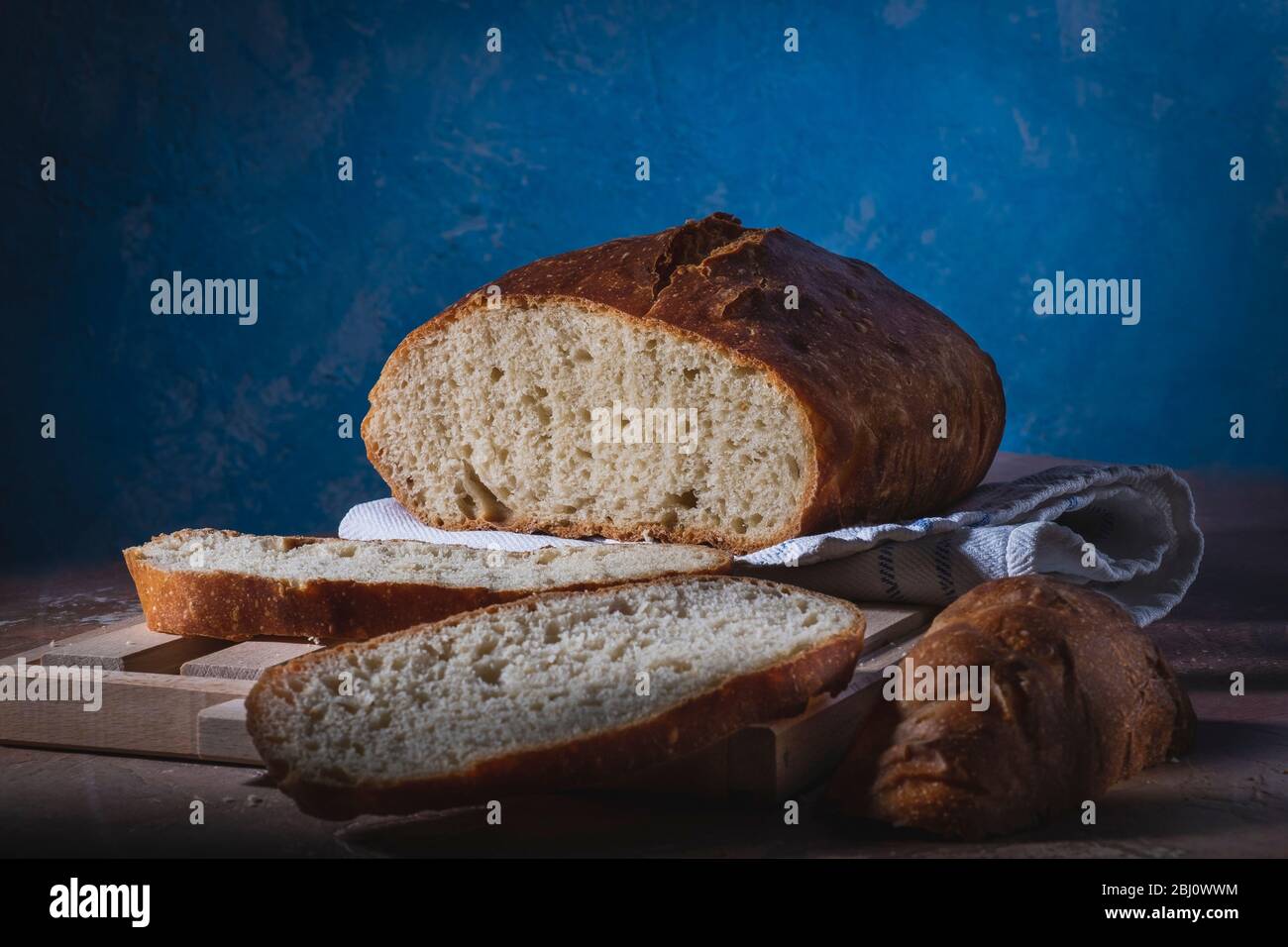 Homemade bread laid on a rustic table in a vintage setting Stock Photo ...