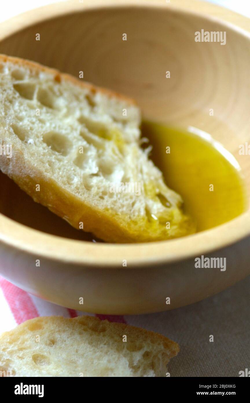 Extra virgin olive oil with rustic bread to dip in it Stock Photo - Alamy
