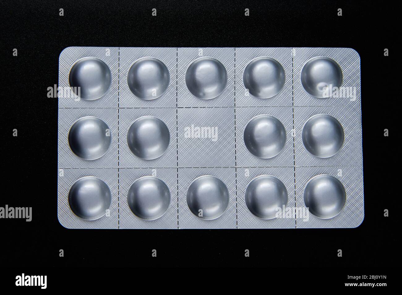 pills in pack on black background simple Stock Photo - Alamy