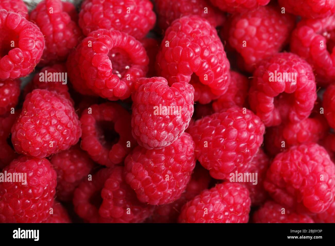 Fresh raspberries background Stock Photo - Alamy