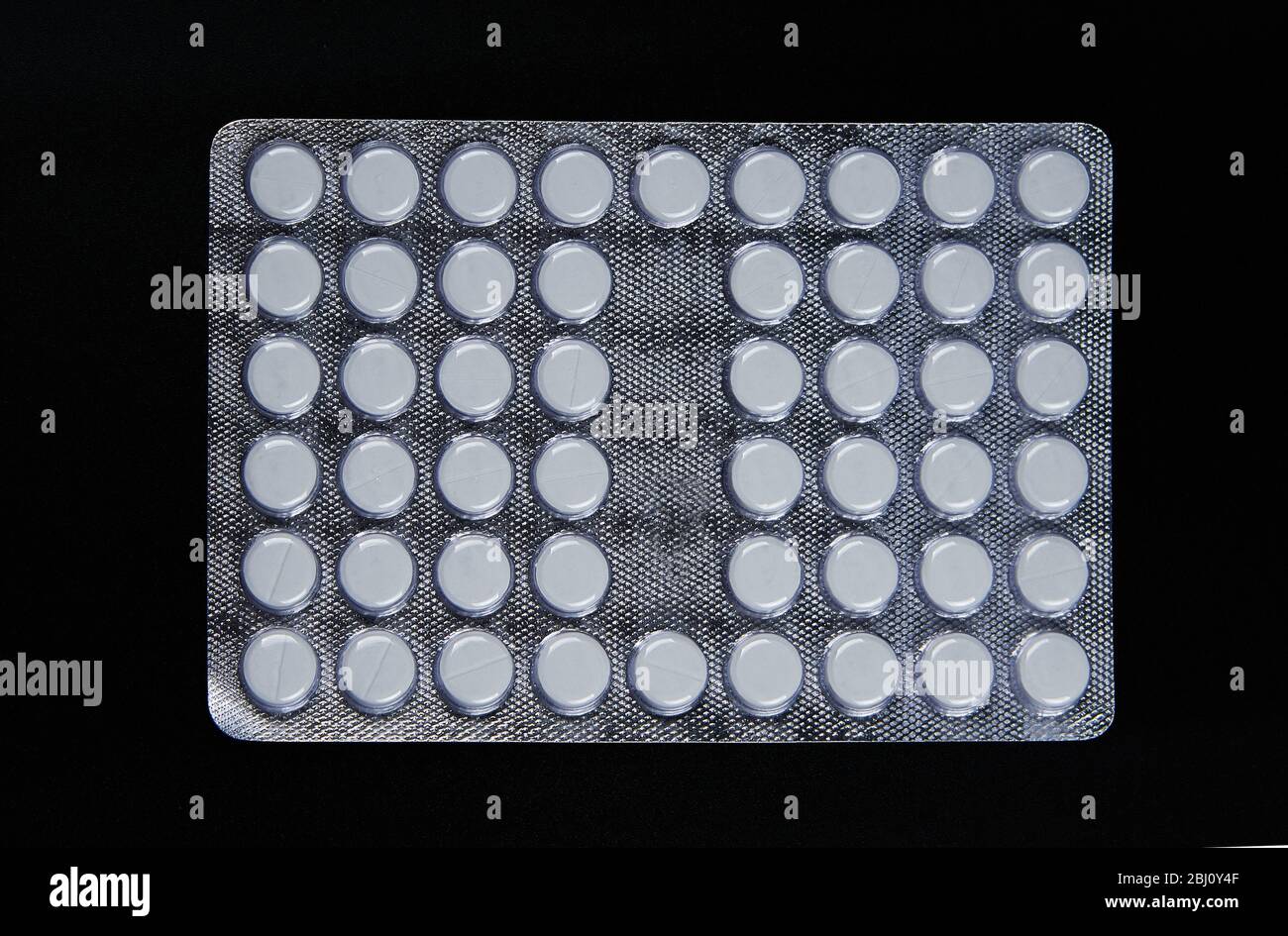 pills in pack on black background white Stock Photo - Alamy