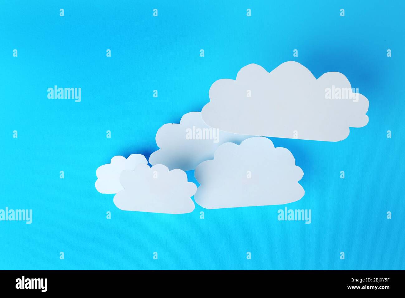 White paper clouds on blue background. Cloud computing concept Stock ...