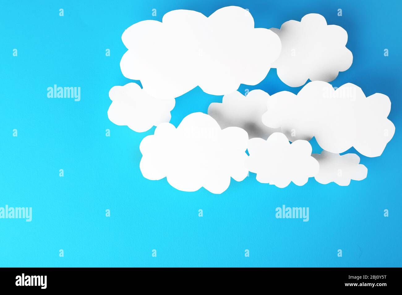 White paper clouds on blue background. Cloud computing concept Stock ...