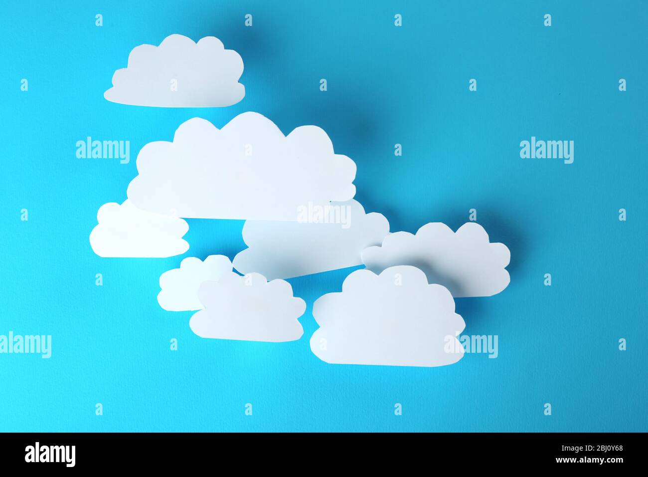 White paper clouds on blue background. Cloud computing concept Stock ...