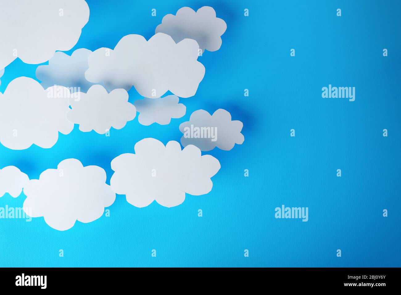White paper clouds on blue background. Cloud computing concept Stock ...
