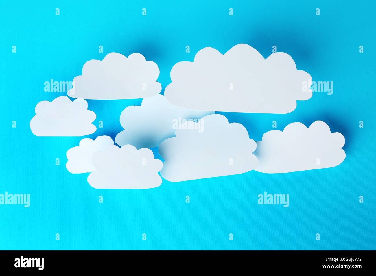 White paper clouds on blue background. Cloud computing concept Stock ...