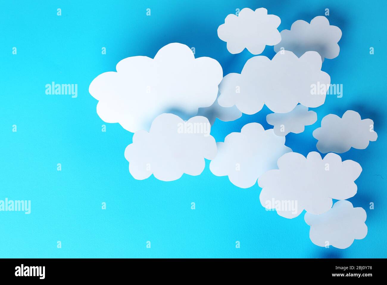 White paper clouds on blue background. Cloud computing concept Stock ...