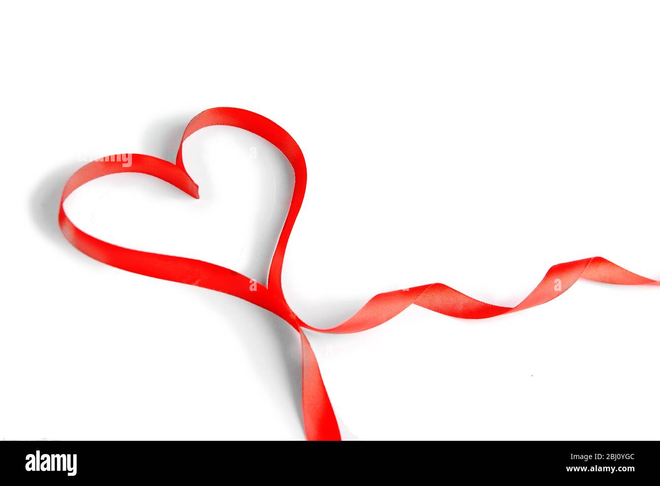 Red ribbon in shape of heart isolated on white Stock Photo - Alamy