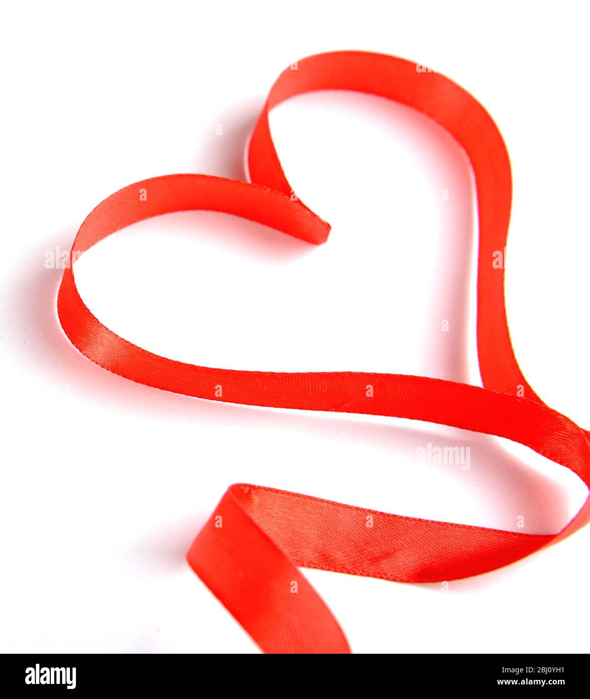 Red ribbon in shape of heart isolated on white Stock Photo - Alamy